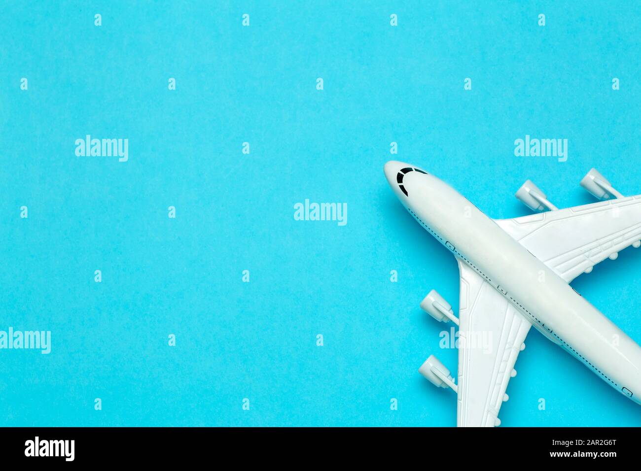 Travel minimal background. Model airplane in flight on an empty colored ...