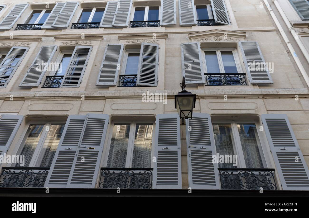 Traditional French house with typical balconies and windows. Paris ...