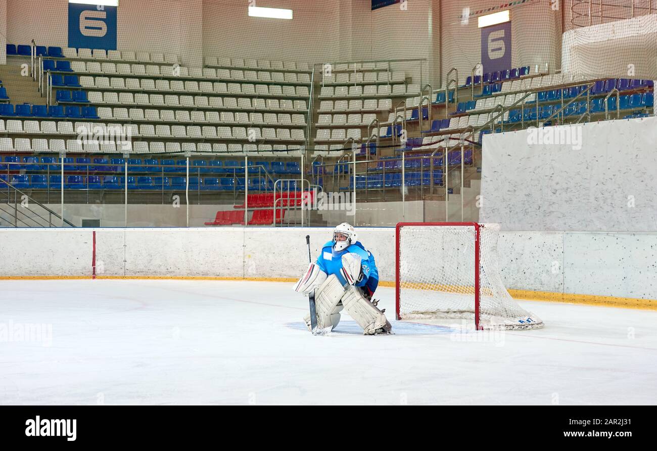 hockey goalie in blue uniform on goal Stock Photo - Alamy