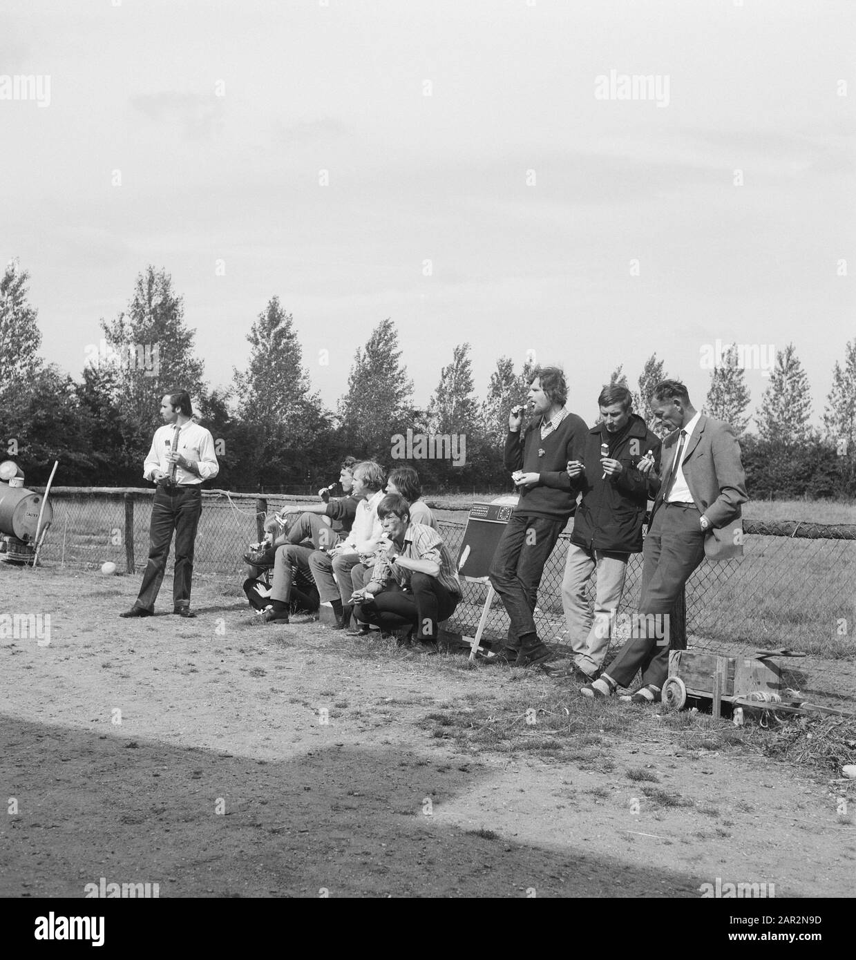 men, terrains, fences, sitting, eating Date: undated Keywords: fences ...