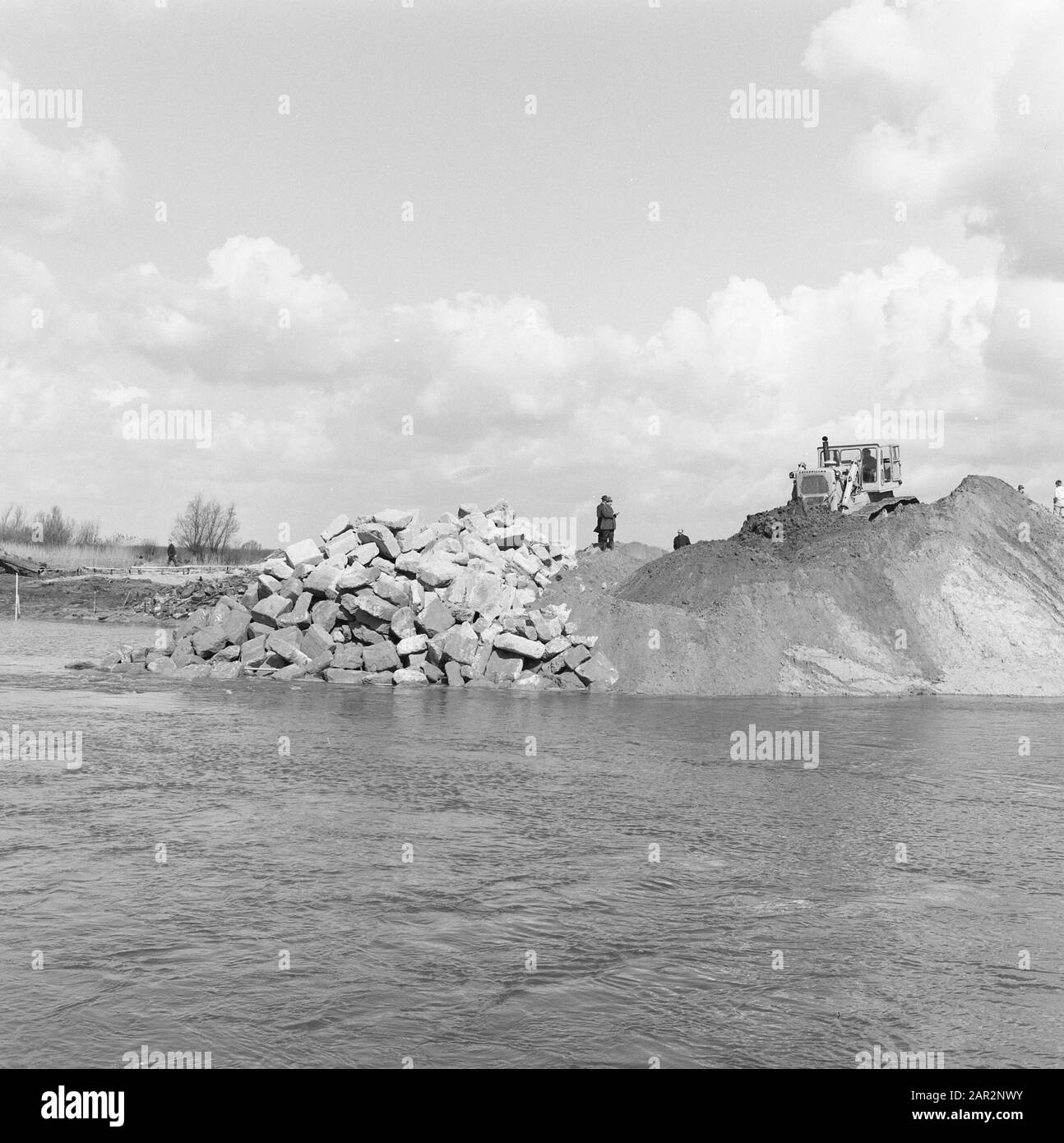 work, workers, bulldozers, boulders, water Date: undated Location ...