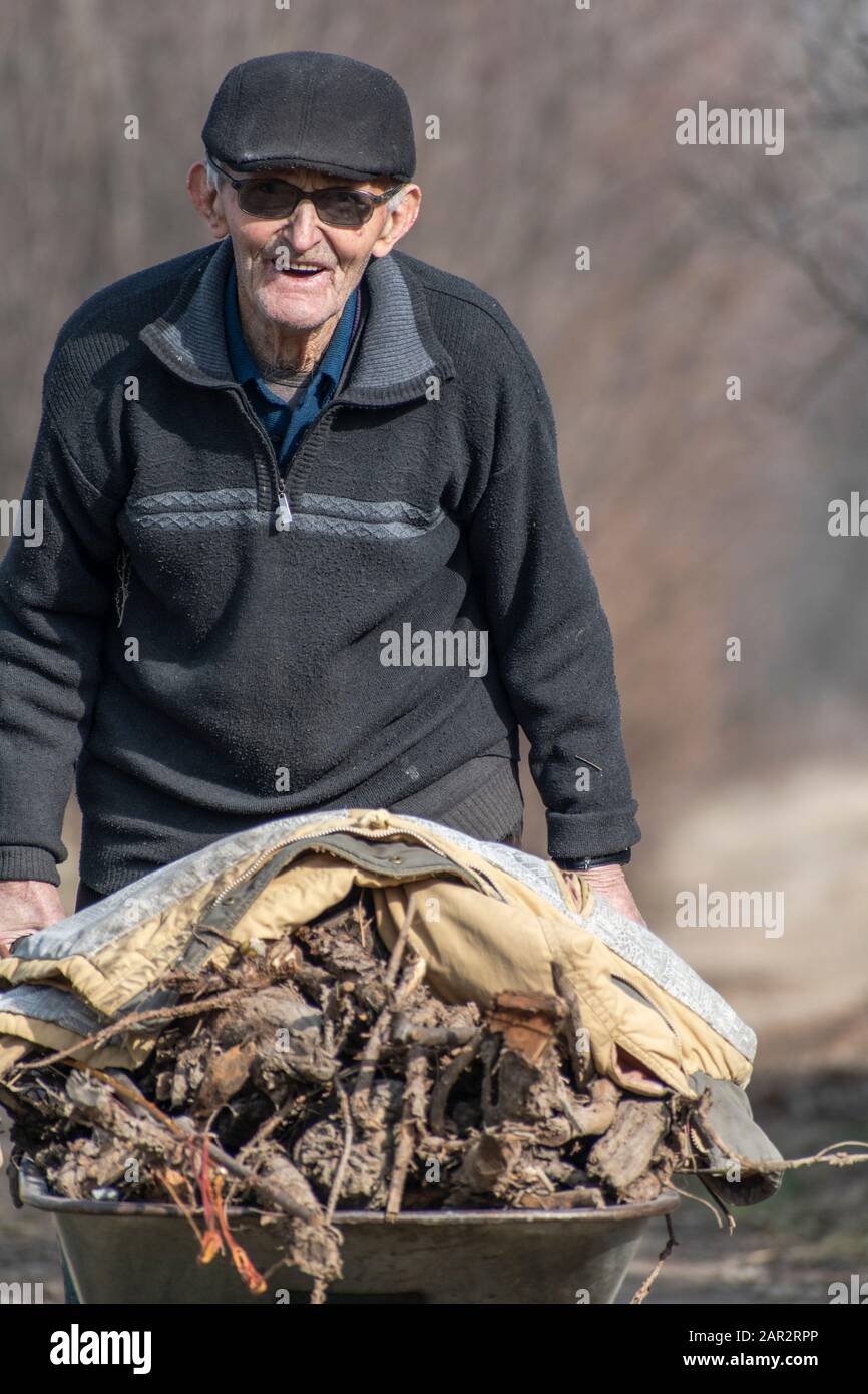 Wheel barrow man garden hi-res stock photography and images - Alamy