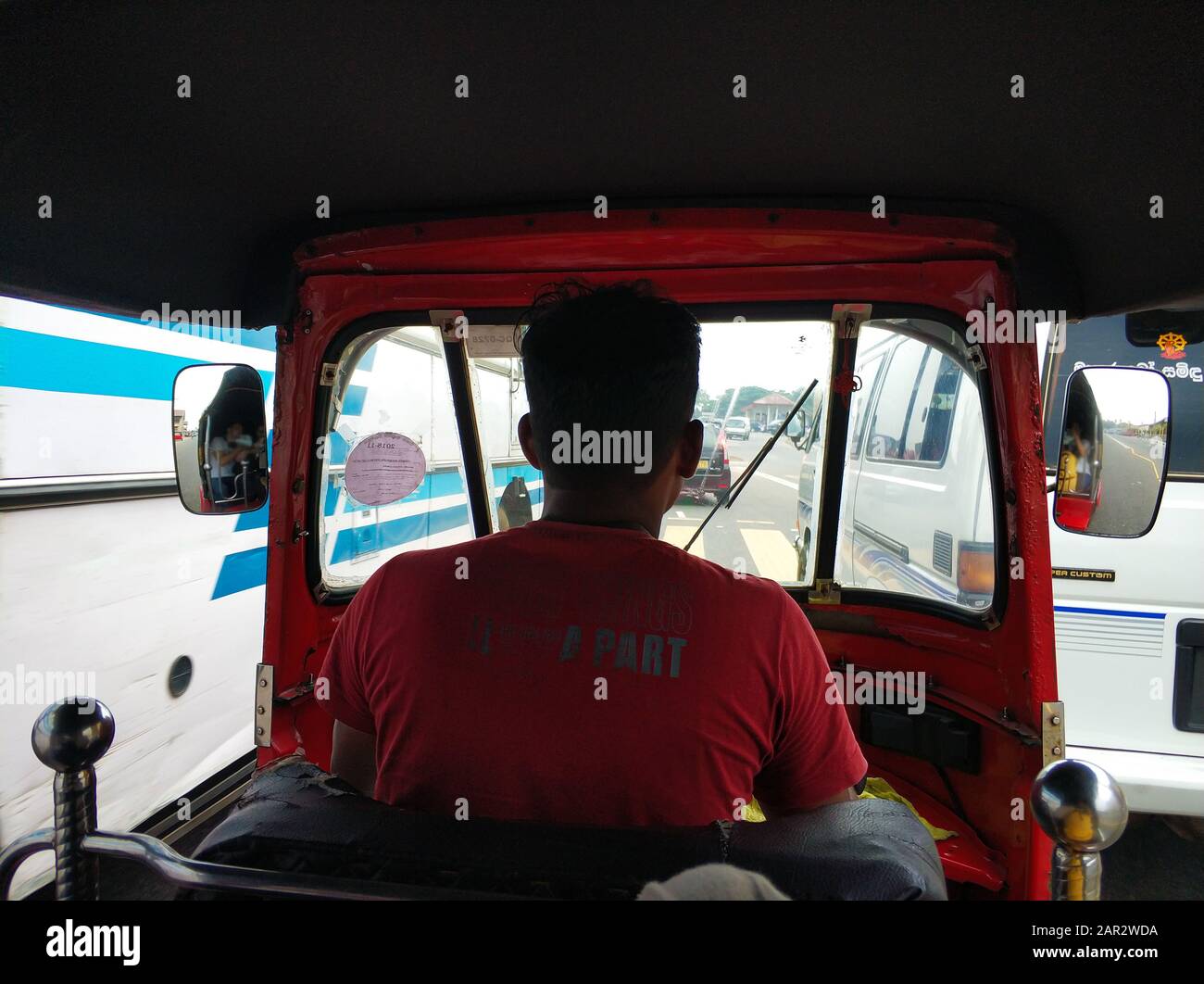 View from tuk-tuk taxi. Driver's back and traffic jam Stock Photo - Alamy
