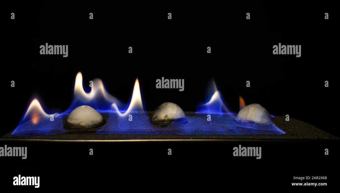 Ice cubes melted by fire on a plate of sand Stock Photo - Alamy