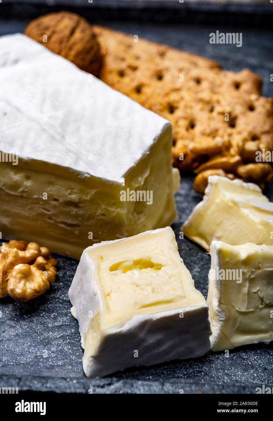 Cheese collection, piece of French brie cheese with white mold close up ...