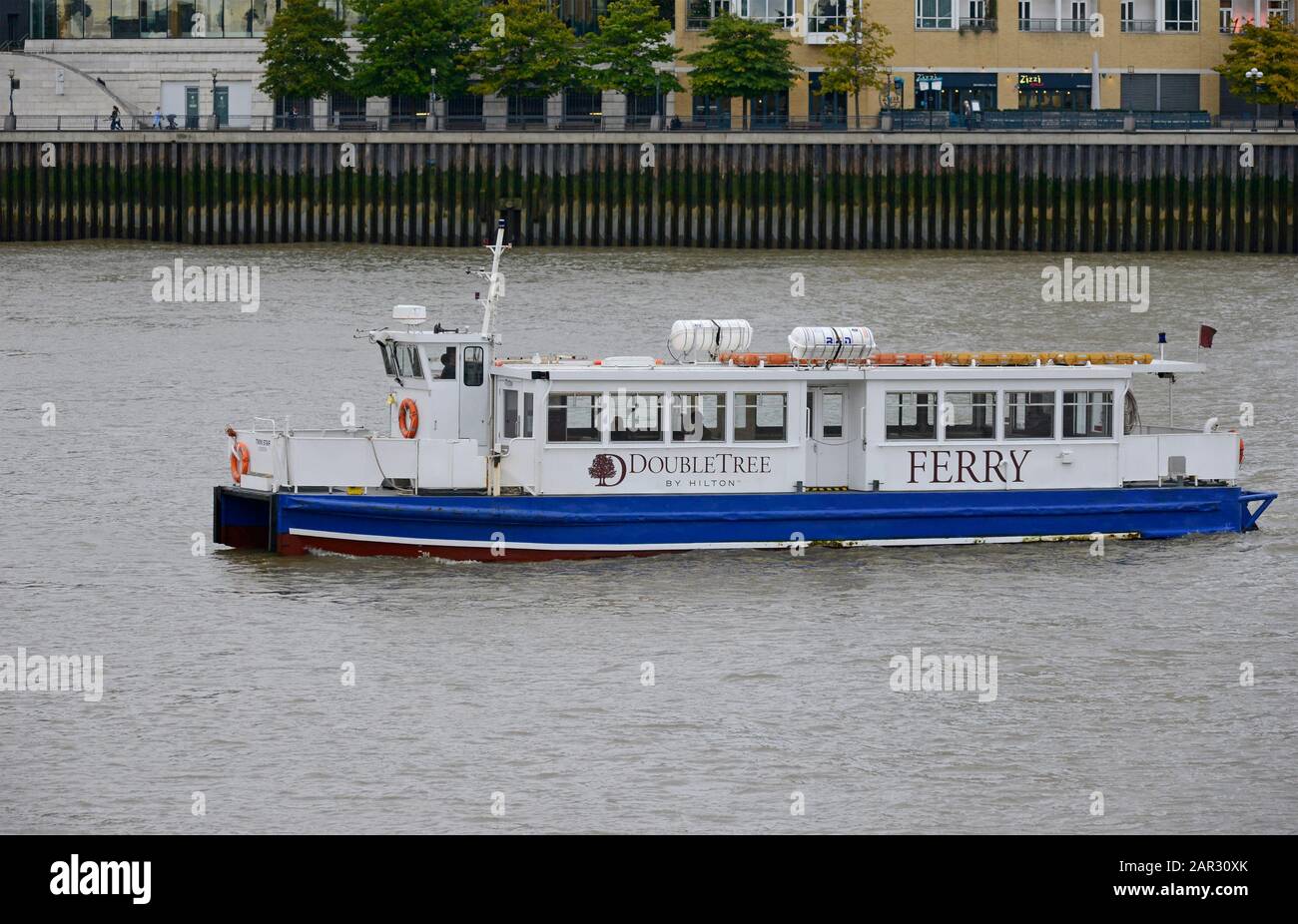 A ferry crosses the River Thames between Canary Wharf and Nelson Dock ...