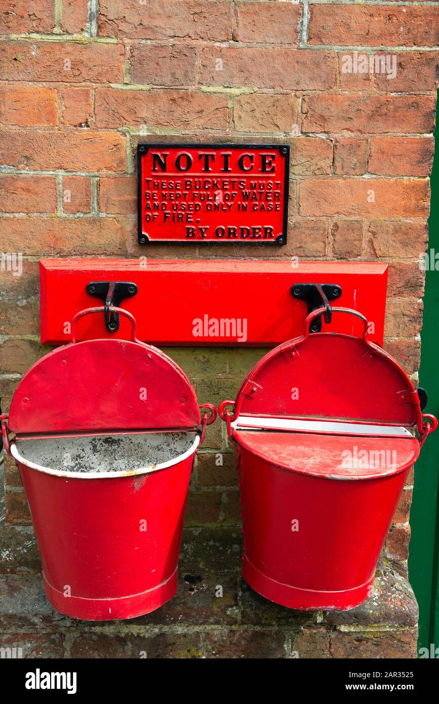 Two bright red water buckets for firefighting at a restored station on ...