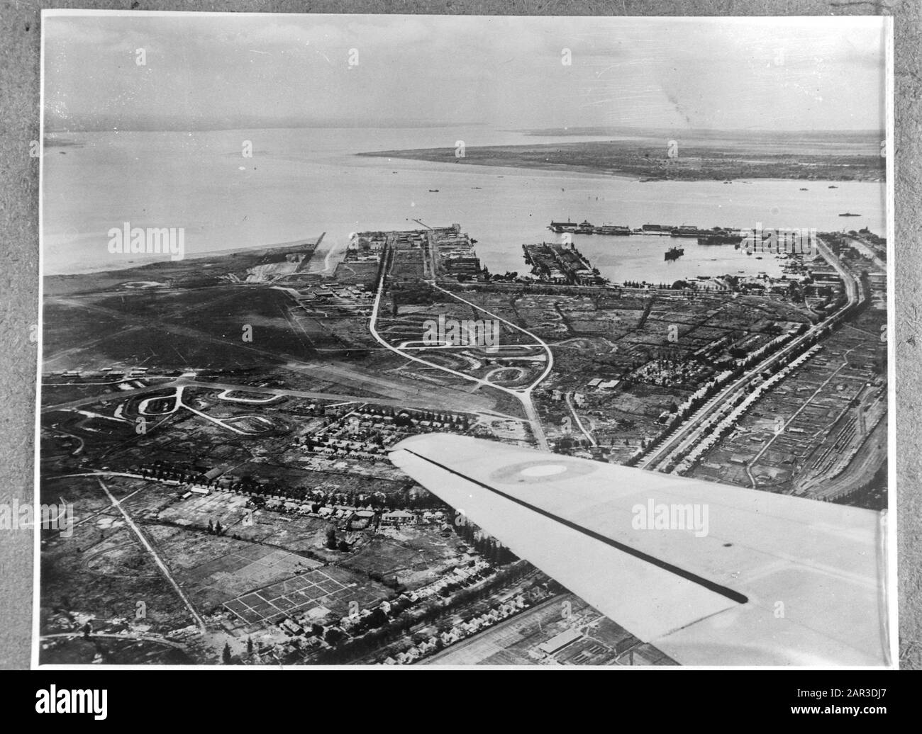 Aerial photograph of an airport by the sea and a port area Annotation ...