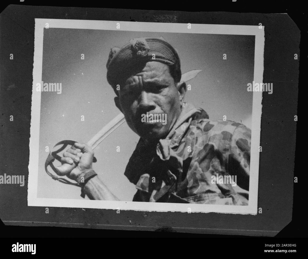 KNIL warrior in camouflage uniform with raised white saber] Annotation ...