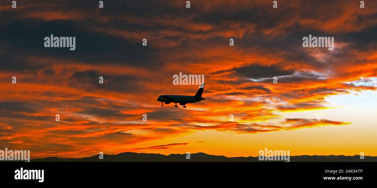 Plane Landing During Sunset in Colorado Stock Photo - Alamy