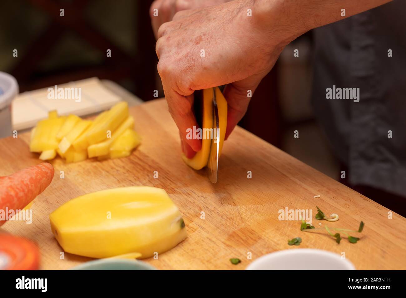 Chef teaching how to cut fruit julienne style for a sushi class Stock ...
