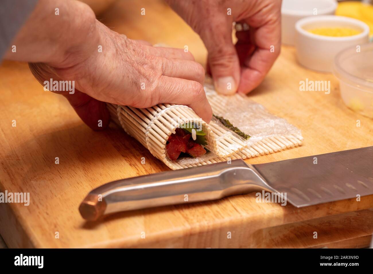 The process of making sushi during a chef's demonstration class in a ...