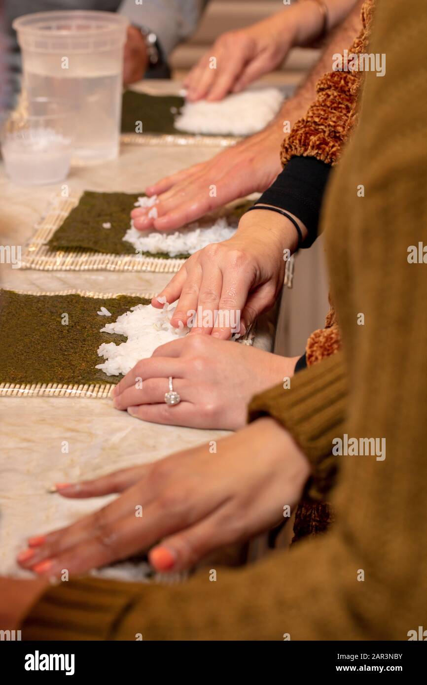 The process of making sushi and slicing during a chef's demonstration ...