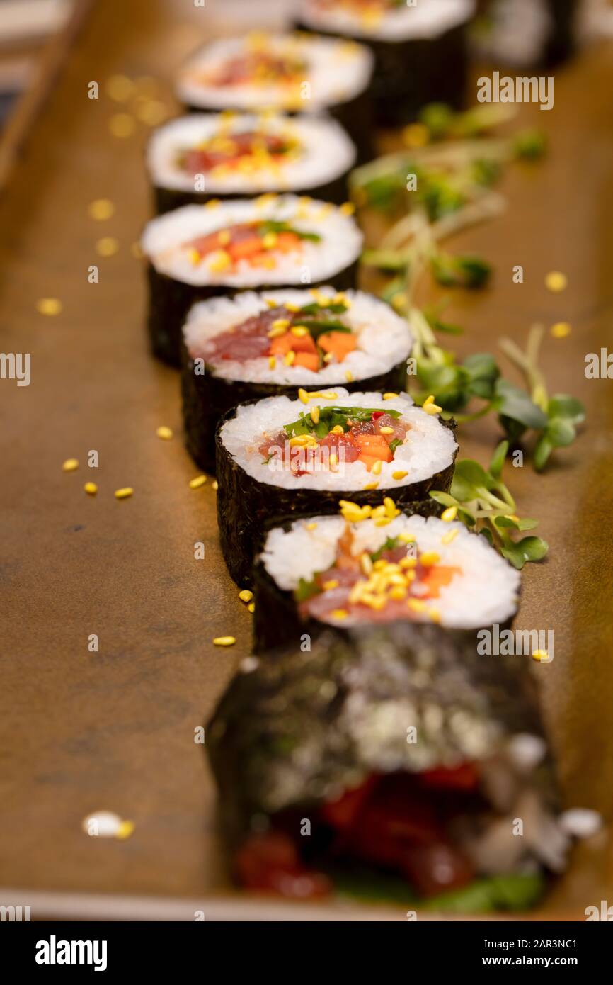 The process of making sushi and slicing during a chef's demonstration ...