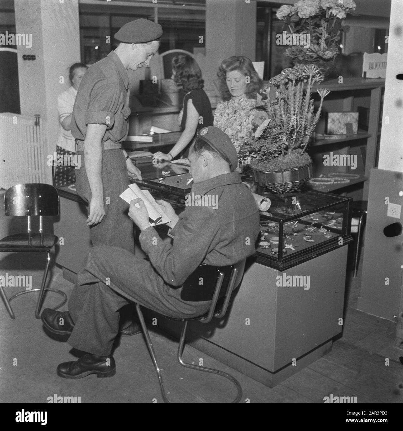 Department Store. Two soldiers at counter behind which saleswoman Date ...