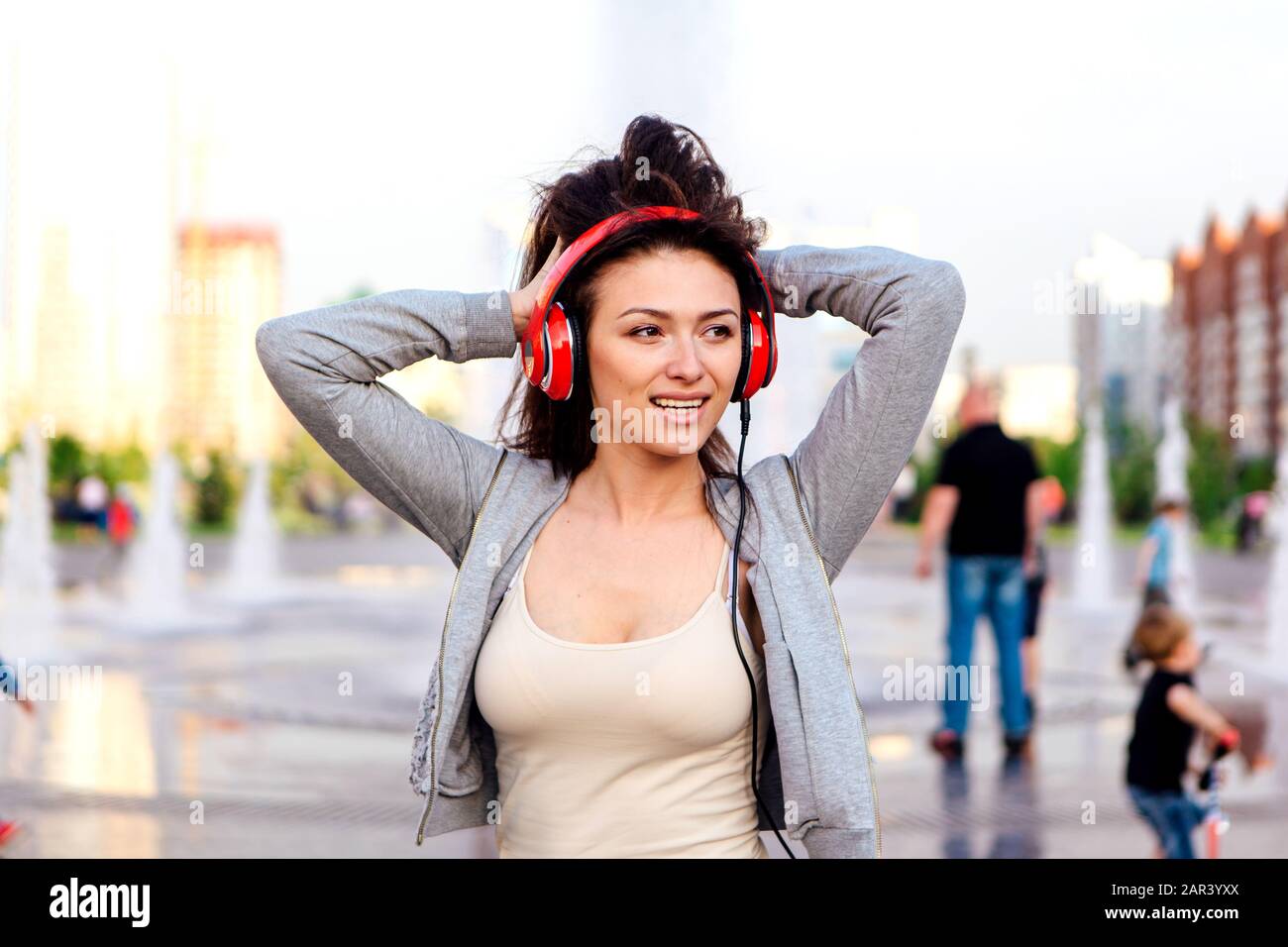 Girl listening to music streaming with headphones and making funny face ...