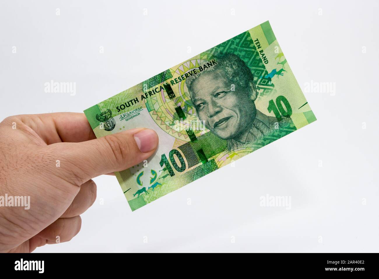 Closeup shot of a person holding some cash over a white background ...