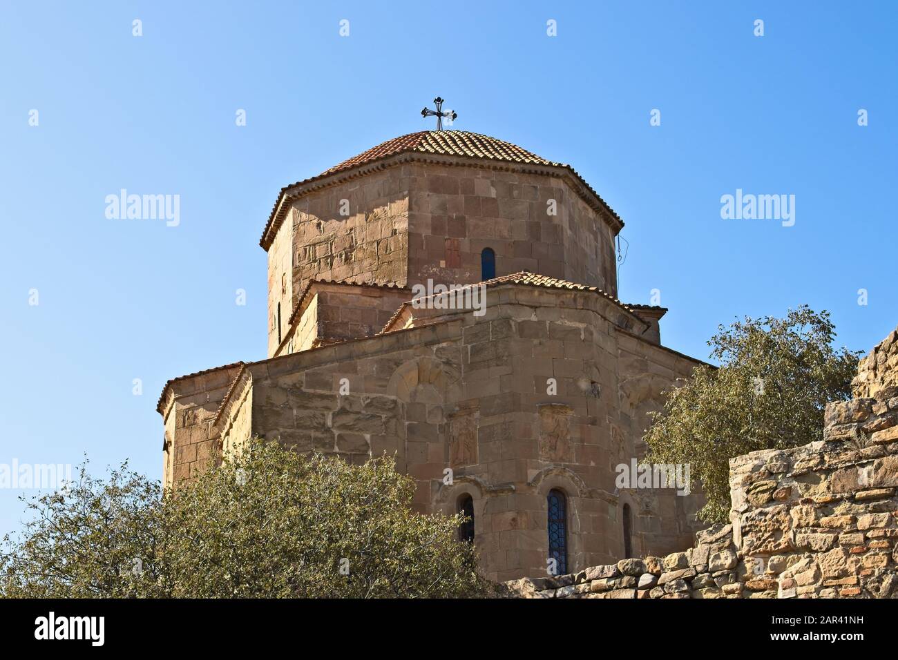 Low angle shot of the historic Jvari Monastery touching the clear sky ...