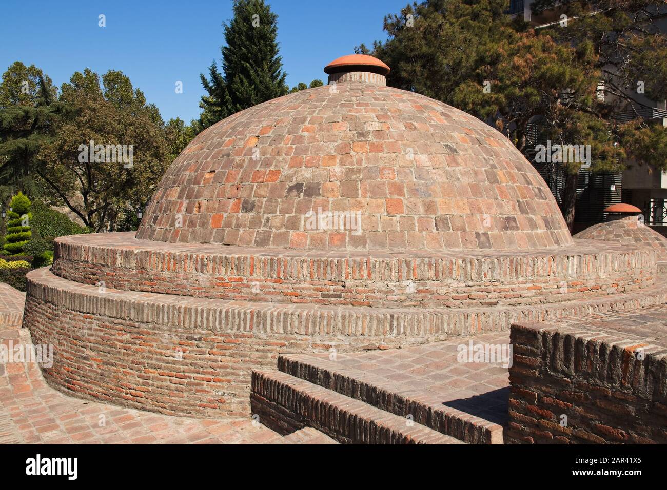 Historic ancient round building surrounded by a forest Stock Photo - Alamy