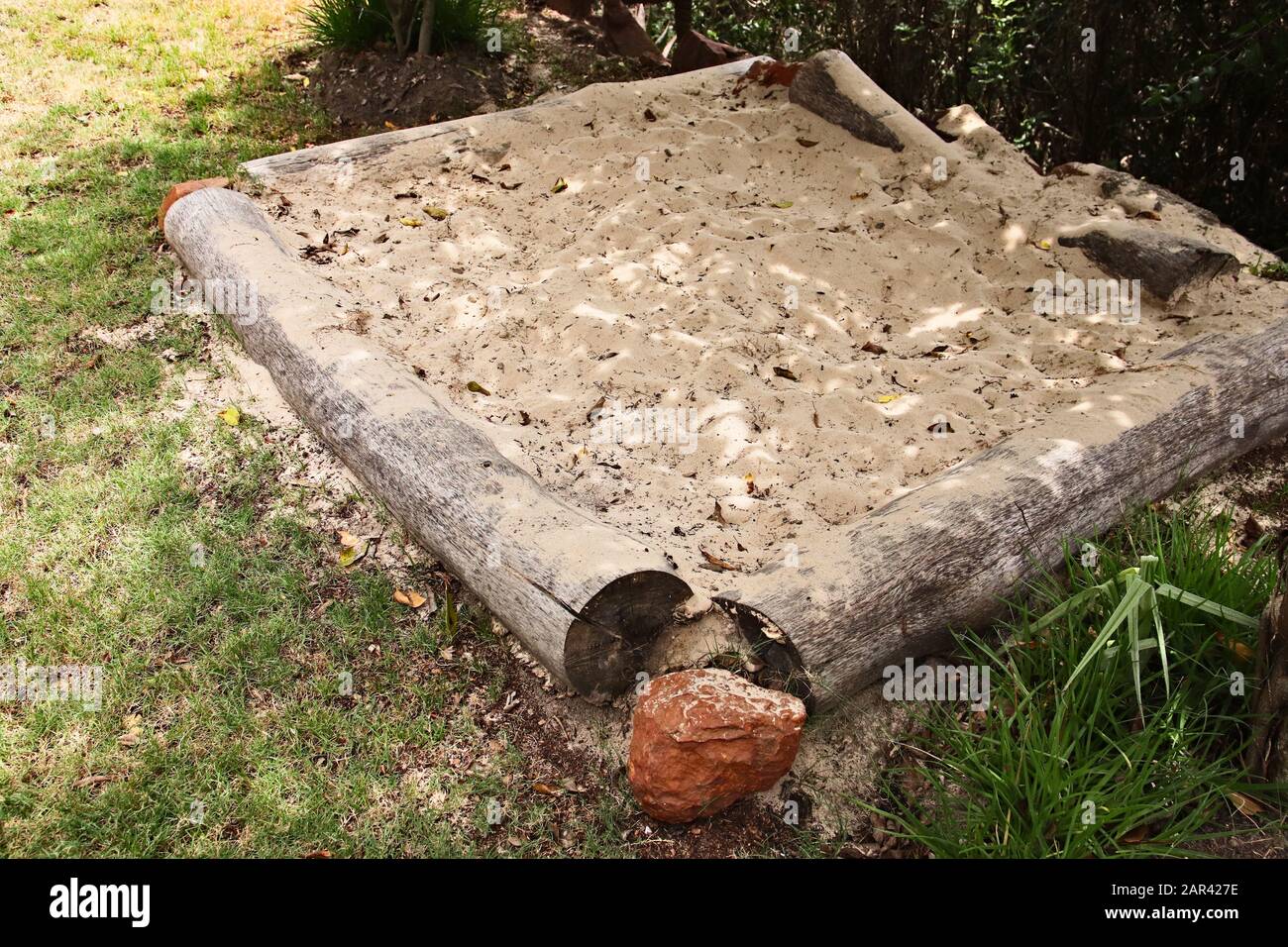An outdoor sand pit with no children in it Stock Photo - Alamy