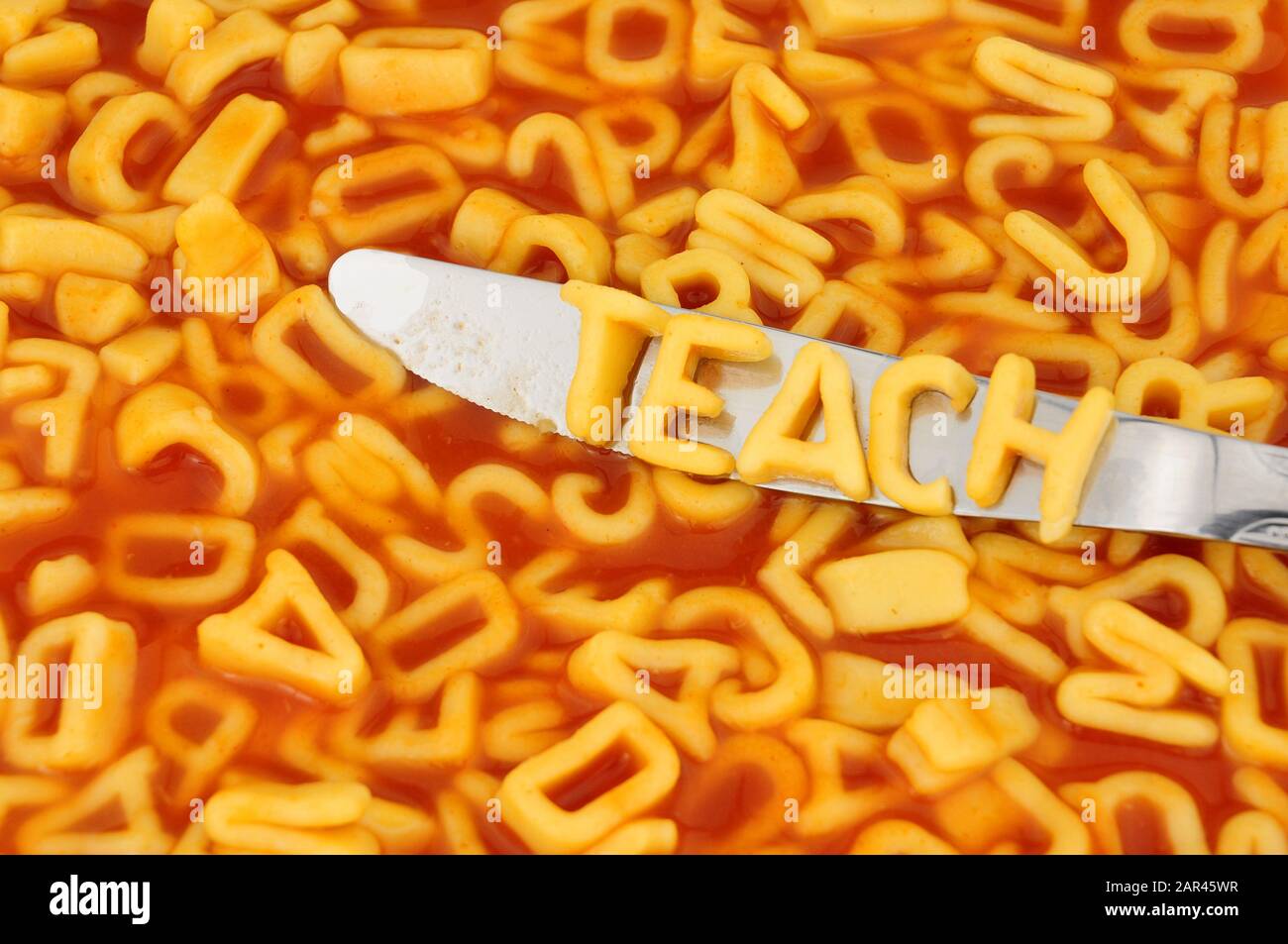 Alphabet spaghetti spelling teach with random letters in tomato sauce ...