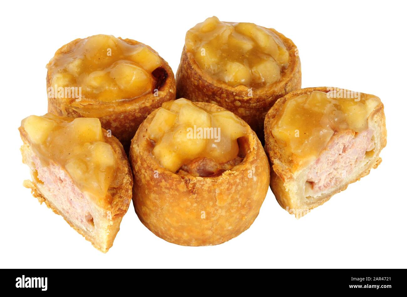 Crusty apple sauce topped mini pork pies isolated on a white background ...