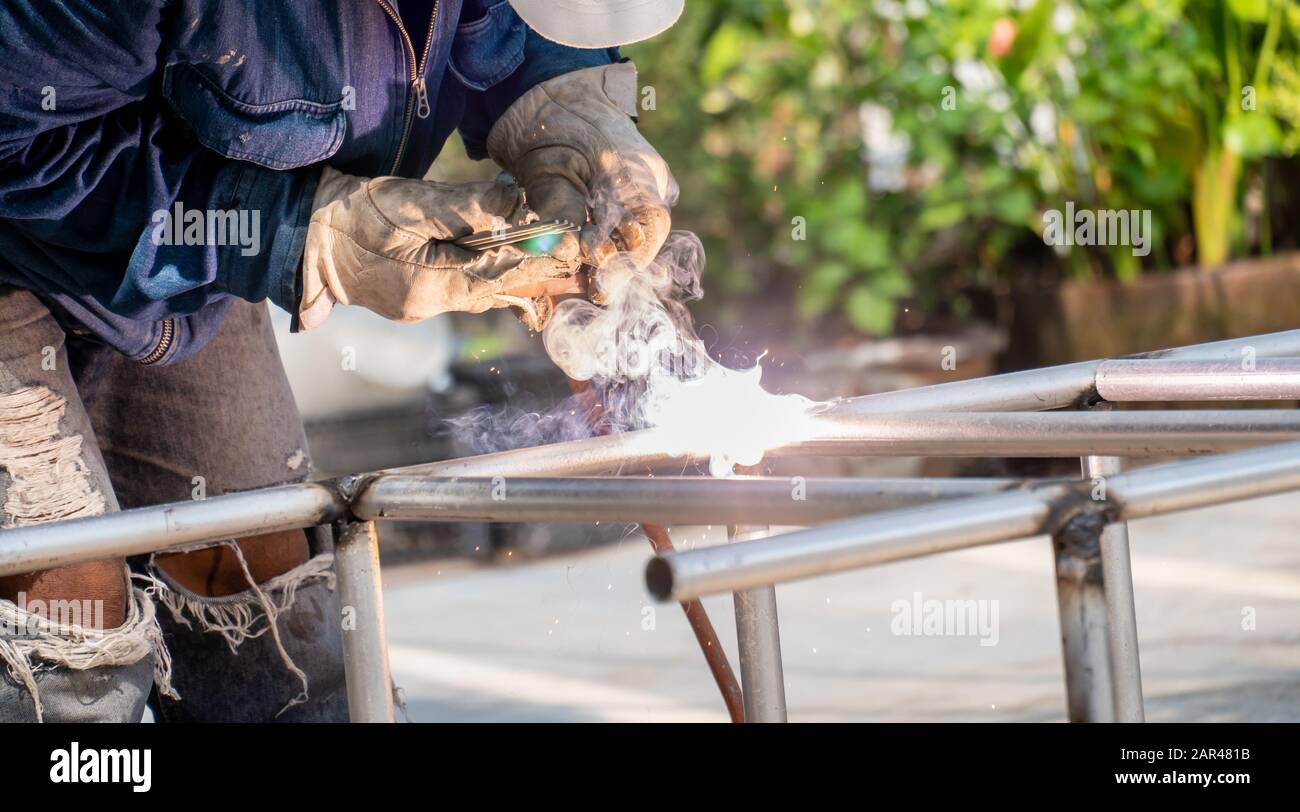The welder is welding the steel frame. Labor and industrial work hard ...