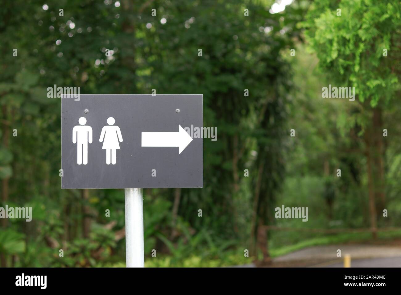 A sign with a male and female symbol showing the way to the restroom ...