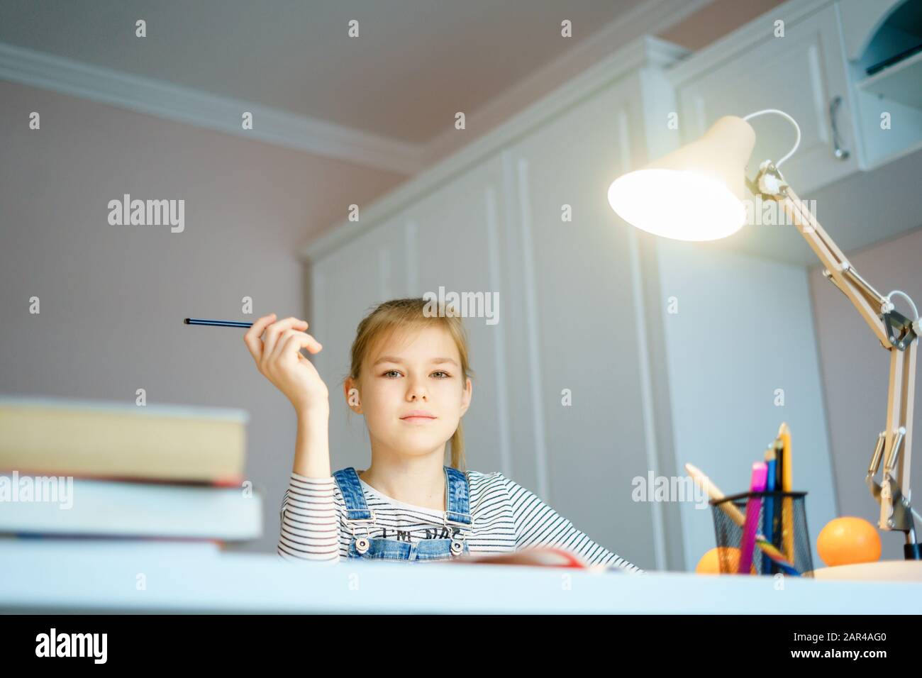 Beautiful girl working on her school project at home Stock Photo - Alamy