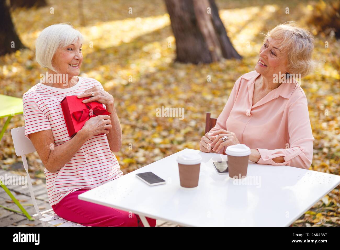Happy lady celebrating her birthday in the park Stock Photo - Alamy