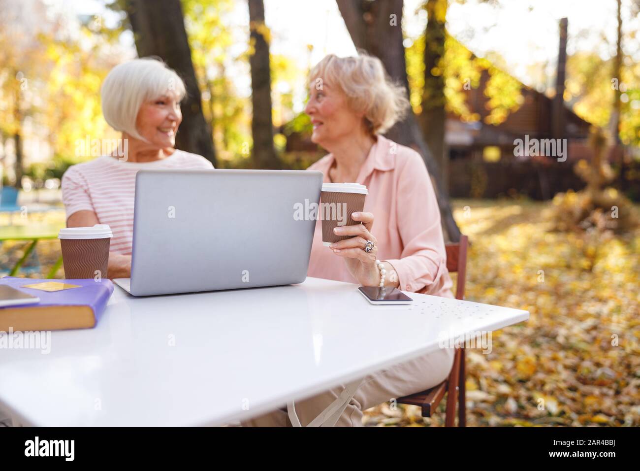 Happy pretty ladies discussing their old friends Stock Photo - Alamy