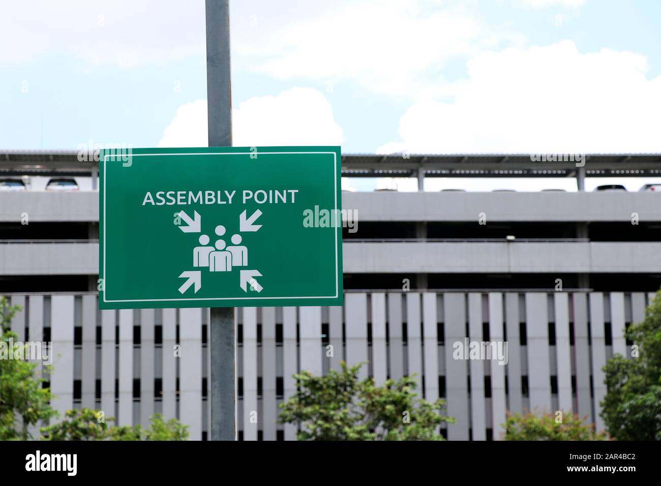 Green white assembly point sign hi-res stock photography and images - Alamy