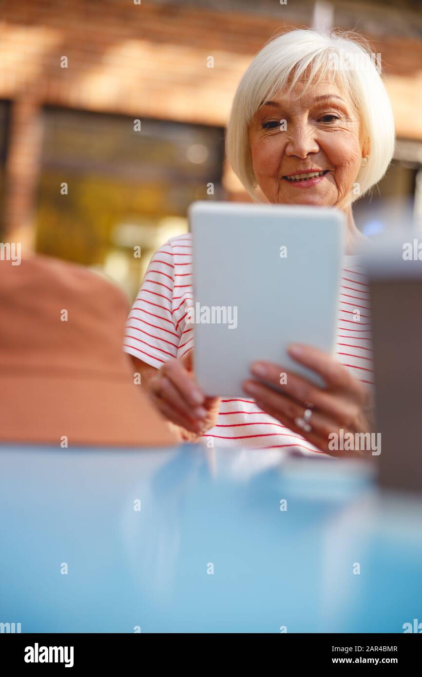 Woman being glad having online conversation with a friend Stock Photo ...