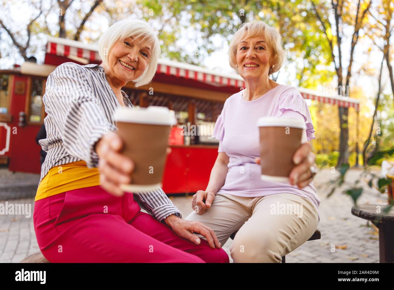 Happy friends having a coffee break together Stock Photo - Alamy