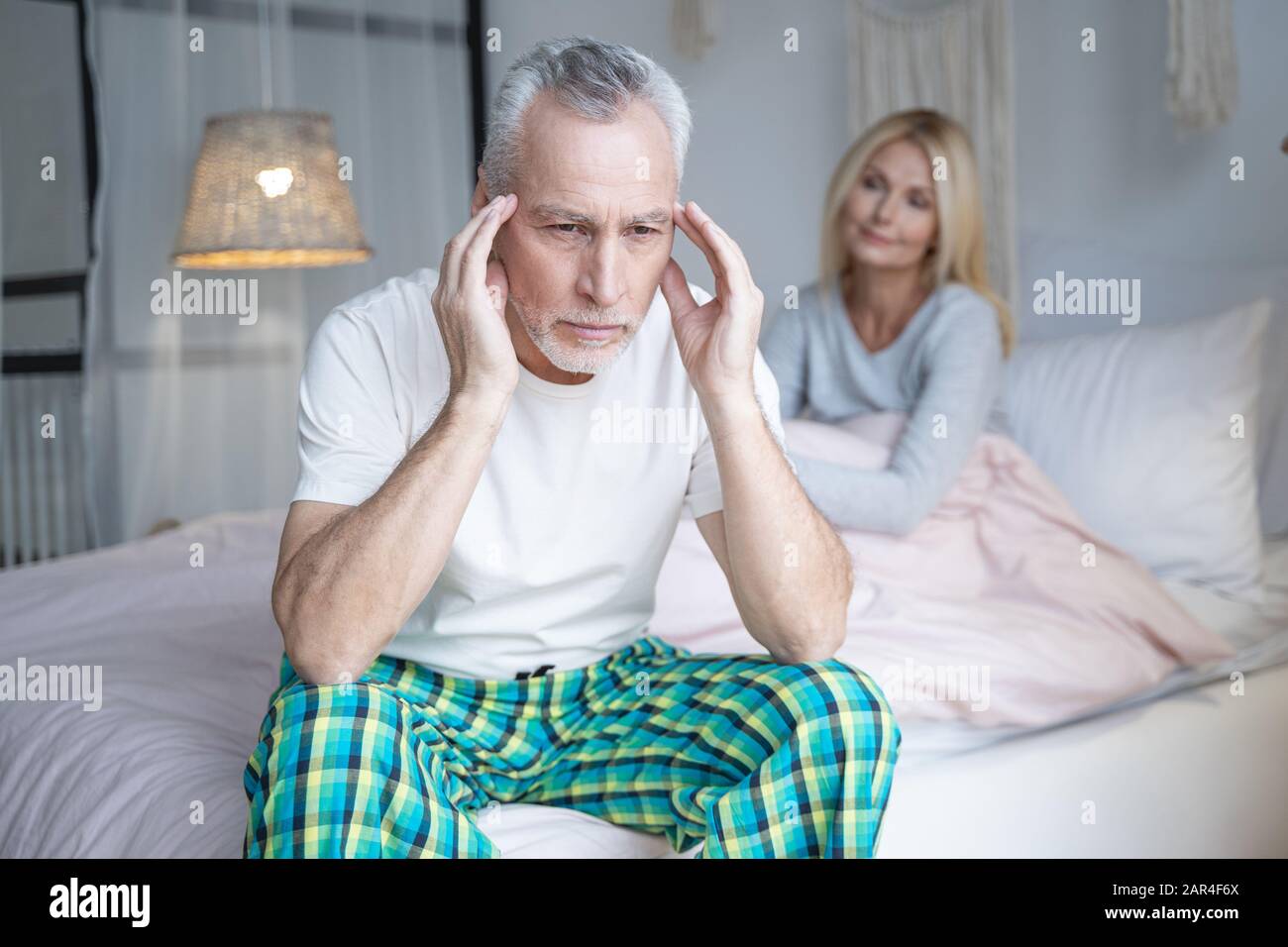 Tired man and his loving wife stock photo Stock Photo - Alamy