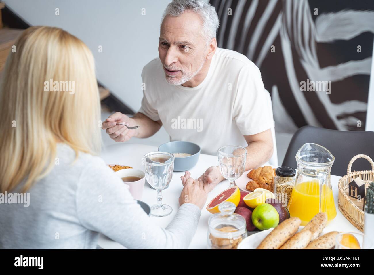 Holding hands and talking during the meal stock photo Stock Photo - Alamy