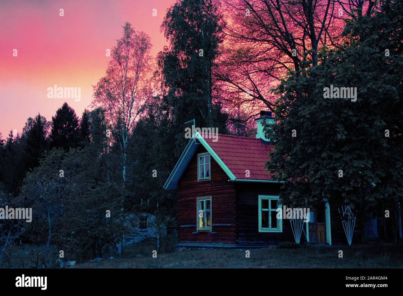 Traditional swedish log cabin and twilight with dramatic red sky Stock ...