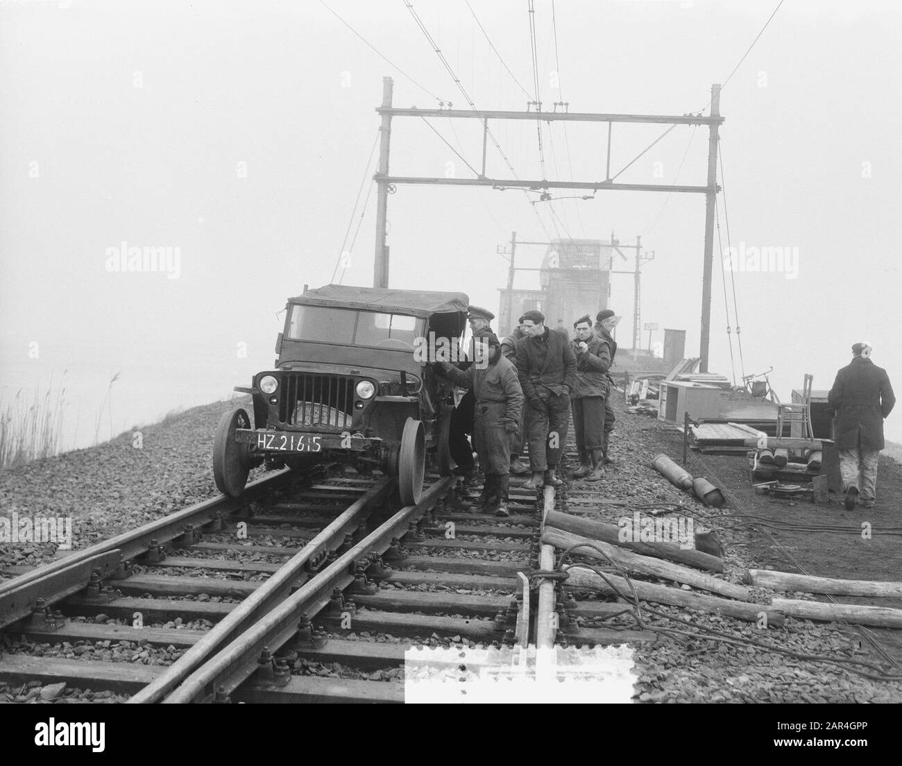 Flooding railway dike repair Moerdijkbrug. Jeep on the rails Date ...