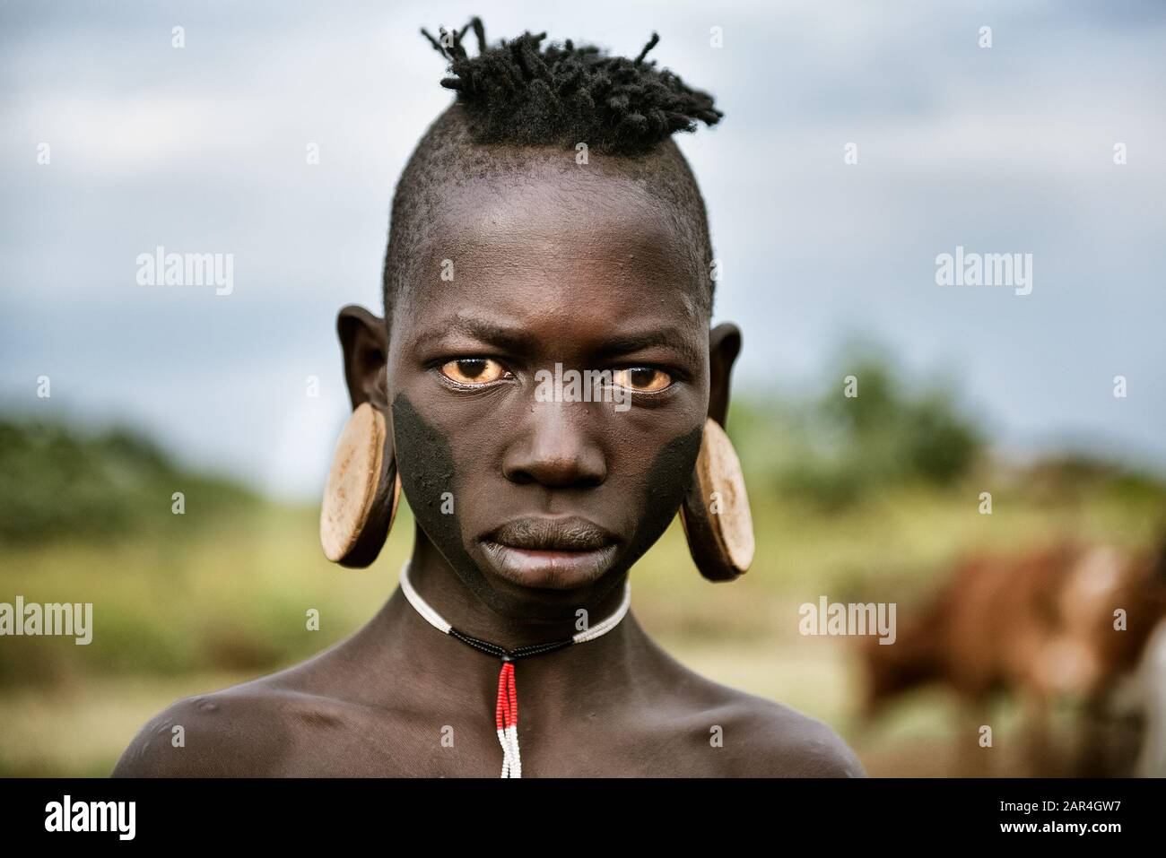 Portrait of a boy from the omo valley hi-res stock photography and ...