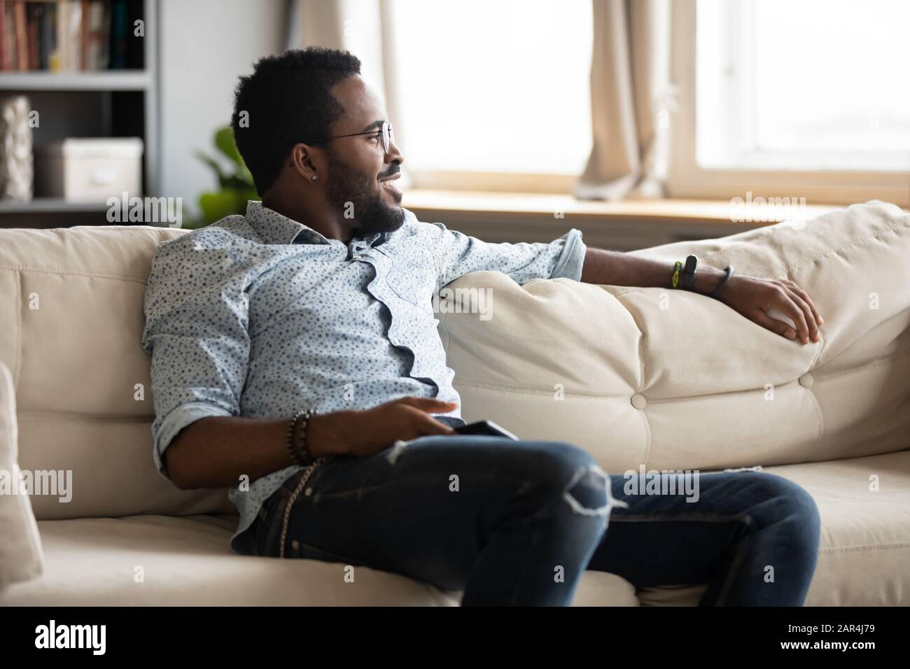 Relaxed guy on sofa hi-res stock photography and images - Alamy