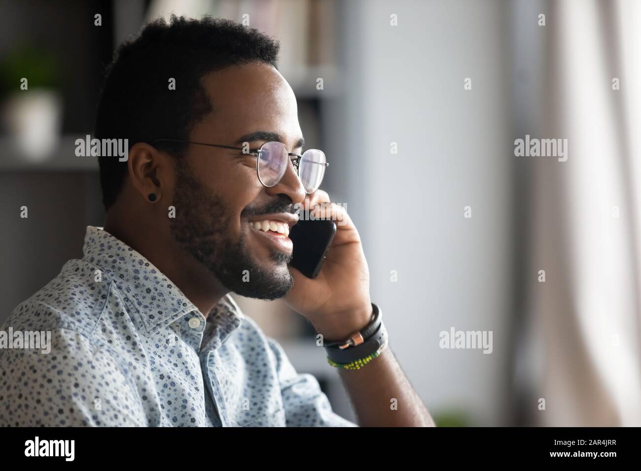 Smiling african business man making business call talking on phone ...