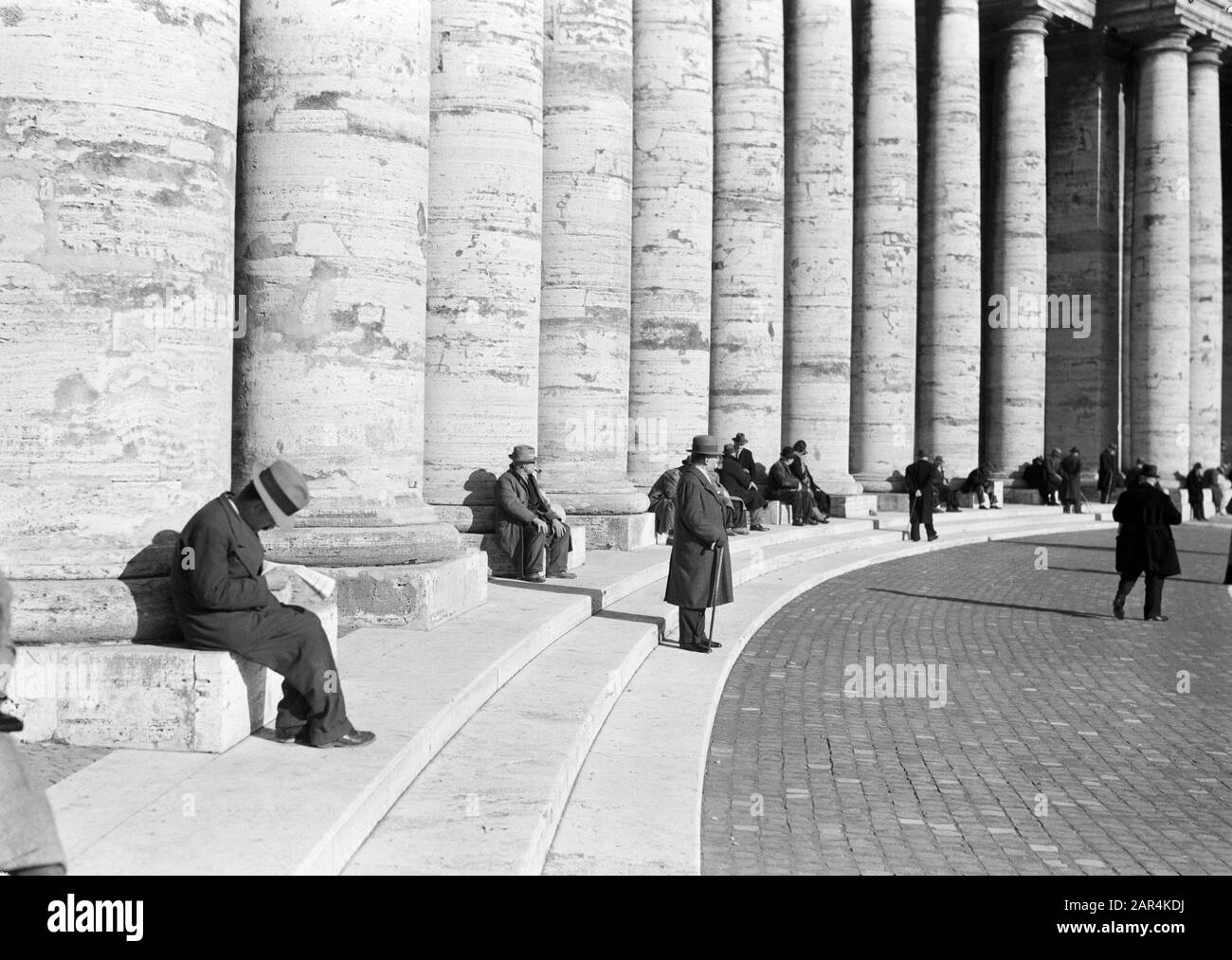 Rome: Visit to Vatican City Part of the colonnade where men sit on the ...