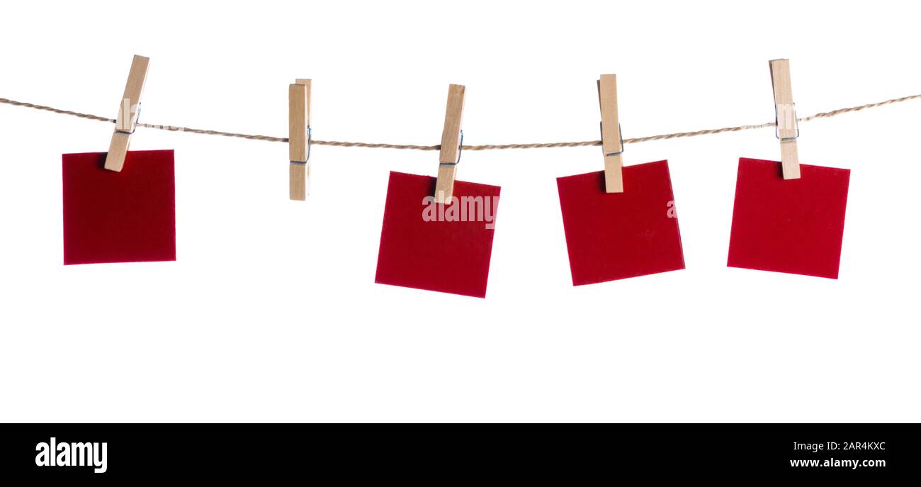 Set of four red blank paper notes held on a string with clothespins ...