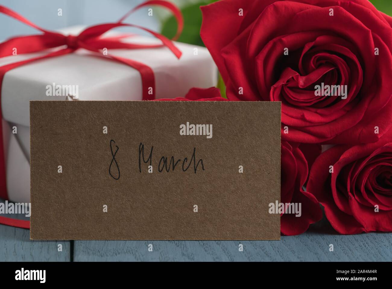 Red roses on wood table with 8 march paper card, shallow focus Stock ...