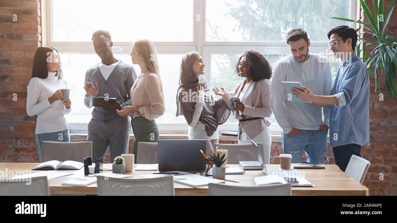 Multiracial young happy people sharing ideas while coffe break Stock ...