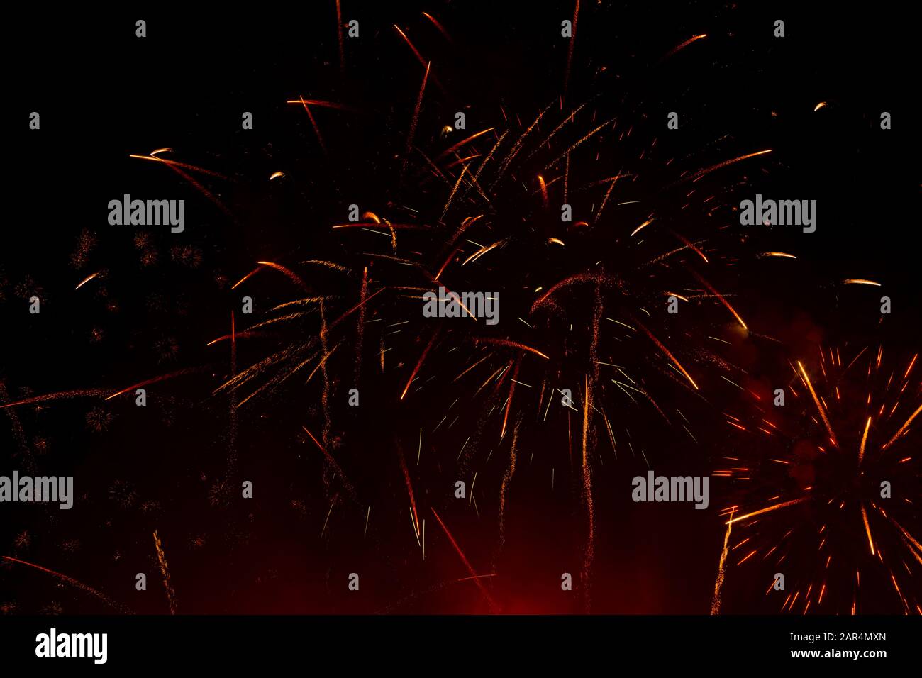 Beautiful orange fireworks display in the urban for celebration on dark ...