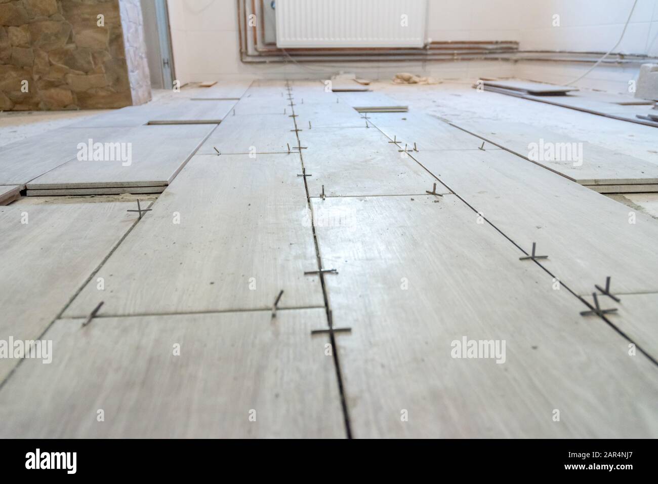 Close up shot of unfinished floor tiles installation in kitchen Stock ...