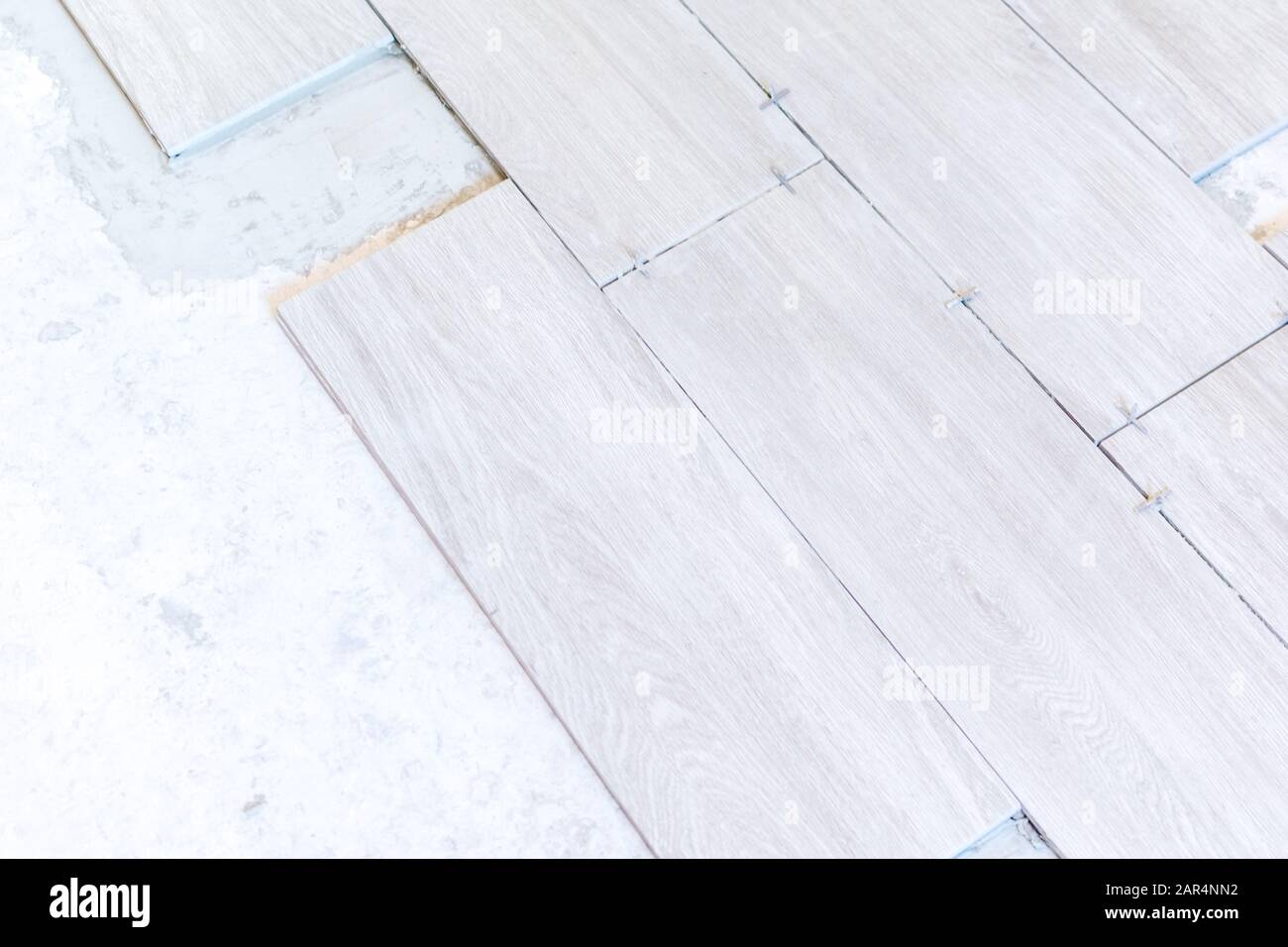 Close up shot of unfinished floor tiles installation in kitchen Stock ...