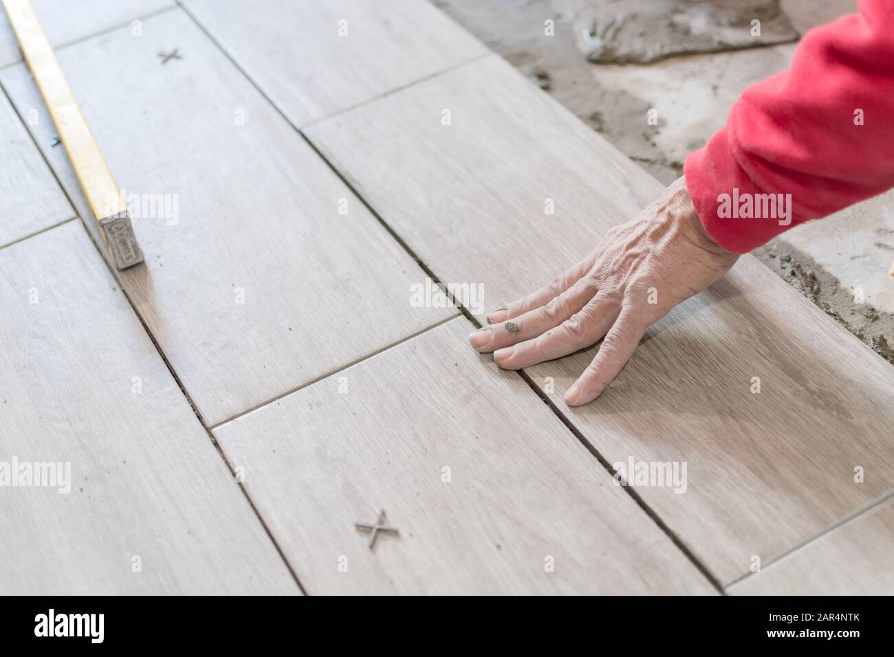 How To Install Rectangular Floor Tiles Man Installing Rectangular