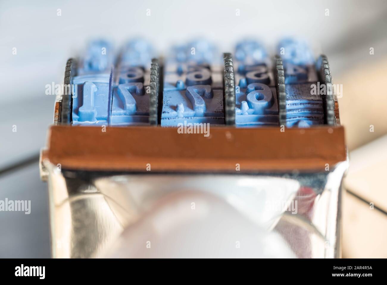 A blue rubber date stamp. Close up macro shot Stock Photo - Alamy